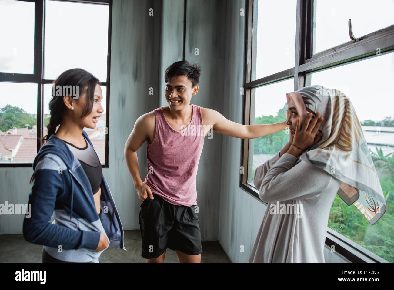 smiling friends after exercising at the gym talking Stock Photo - Alamy
