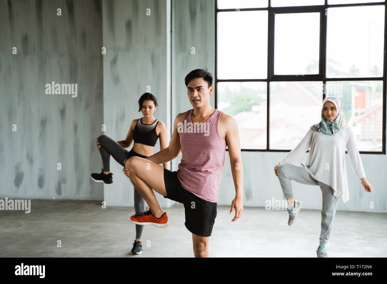 a group of people warming up before doing core gymnastics Stock Photo ...