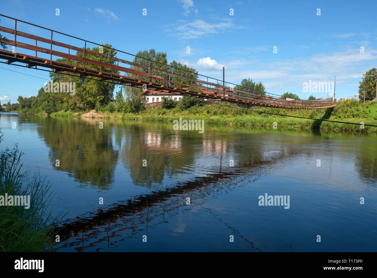 Suspension bridge over the river Msta on a summer day. City Borovichi ...