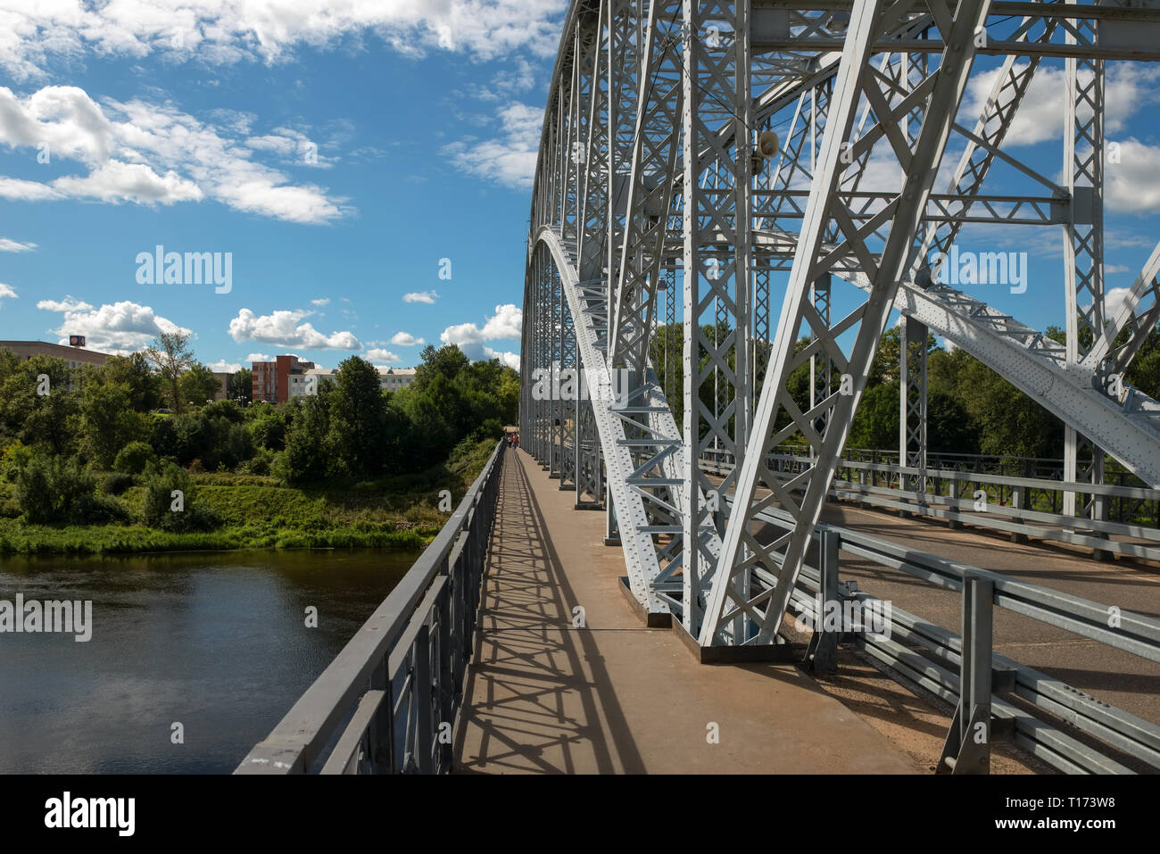 First in Russia steel arch bridge on river Msta in sunny summer day ...