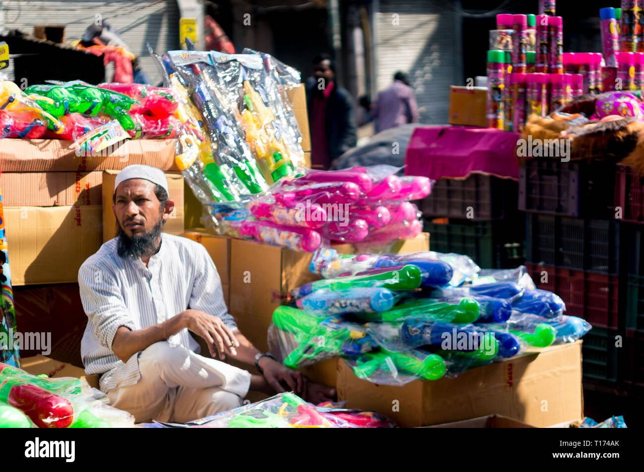 Muslim street vendor selling colors, water guns and other items on ...