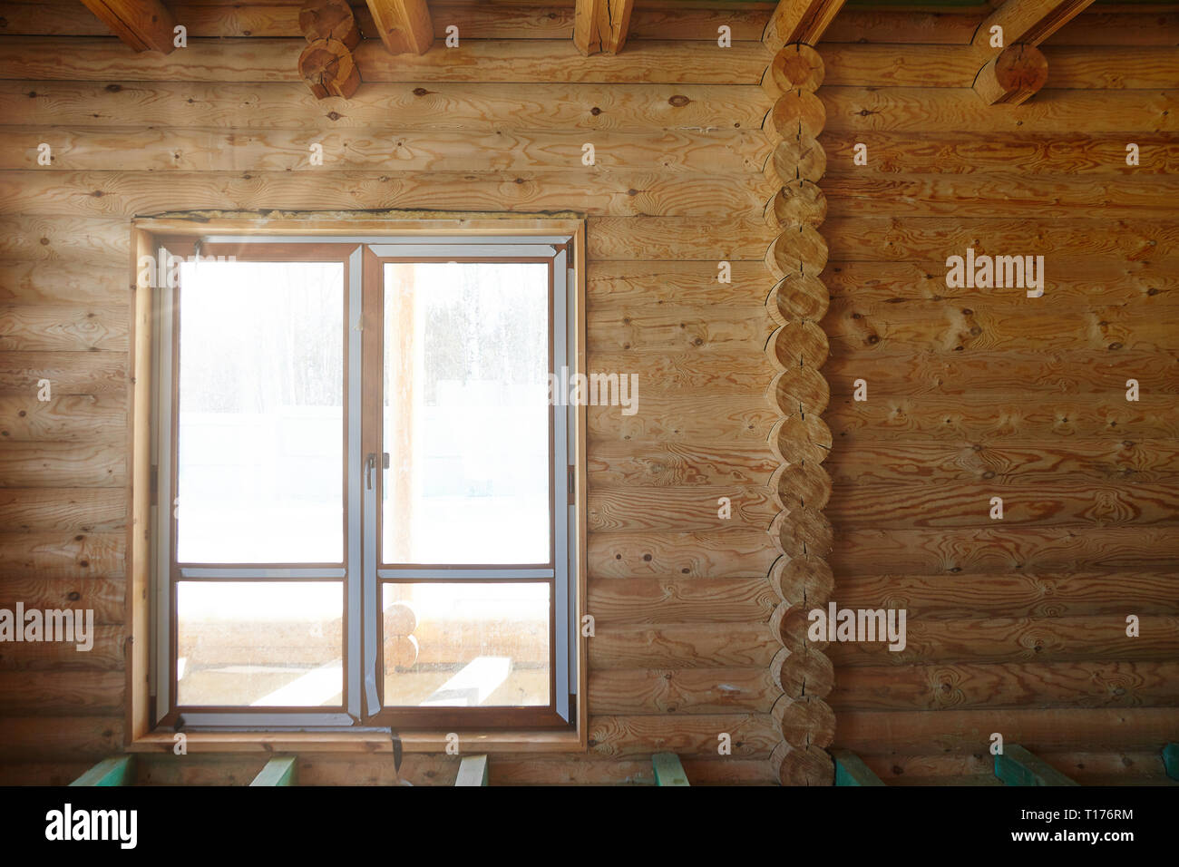 interior view of a wooden house under construction, sun rays through ... interior view of a wooden house under construction, sun rays through ...