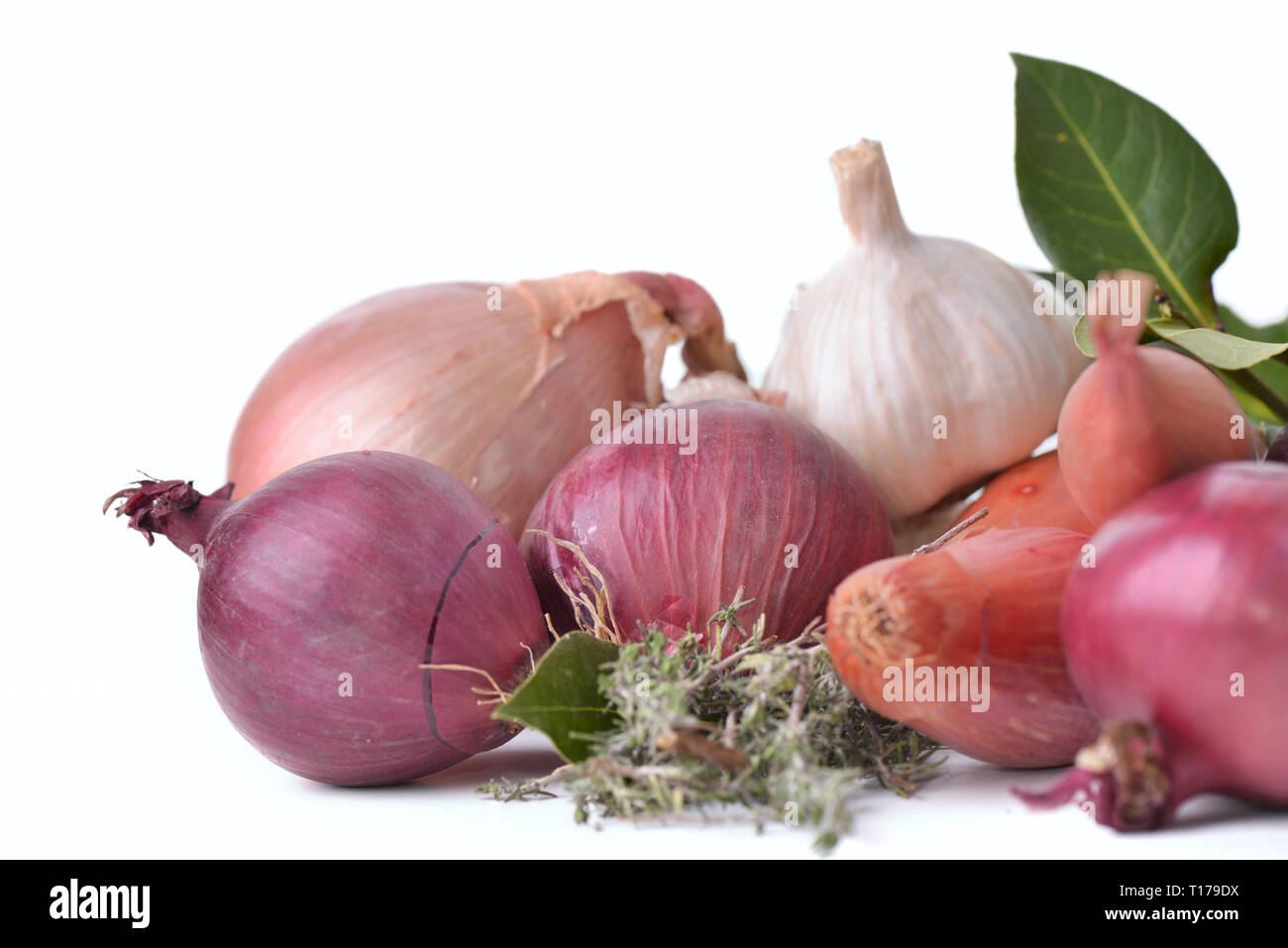 onions, garlics and shallots with herbs on white background Stock Photo ...
