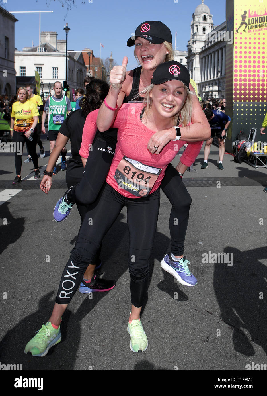 Competitor Aimee Fuller and her Mum cross the finish linne during the ...