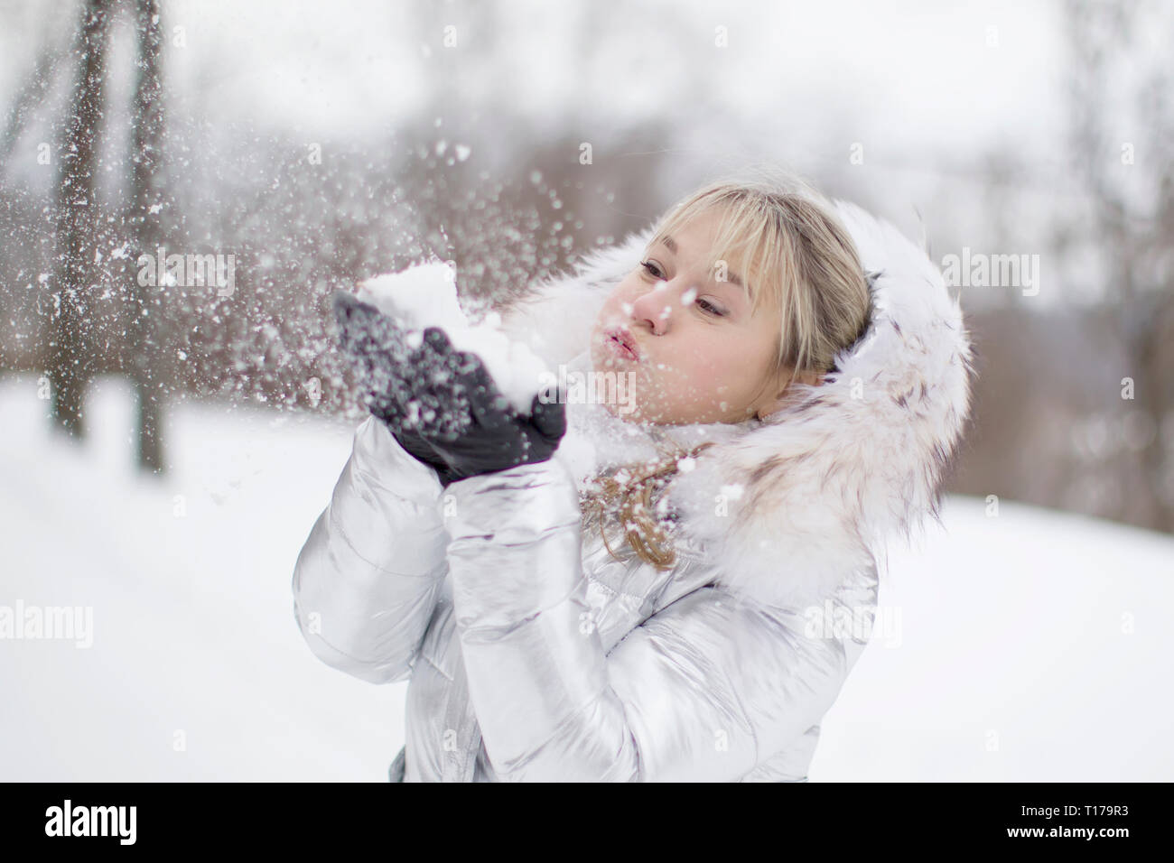 Beautiful woman blowing in snow hi-res stock photography and images - Alamy