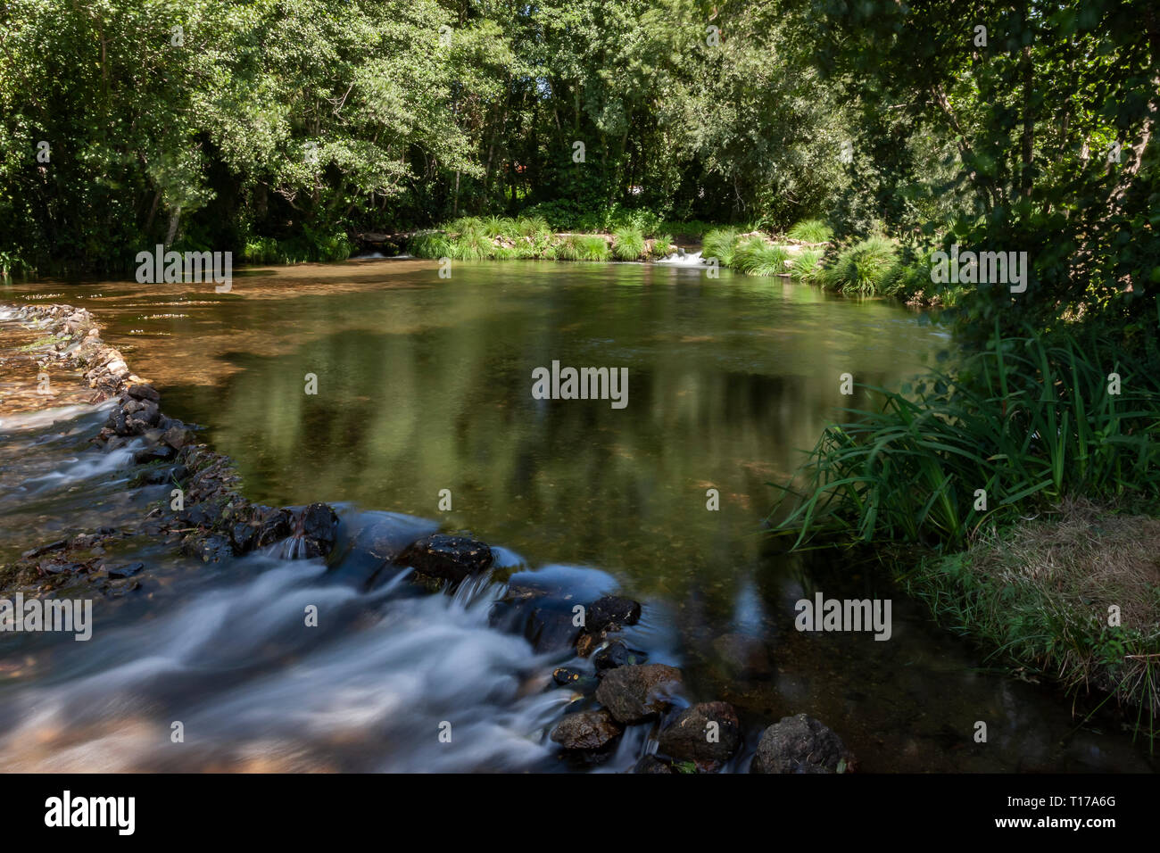 Small dam built by Man with stones and fed with crystalline water where ...