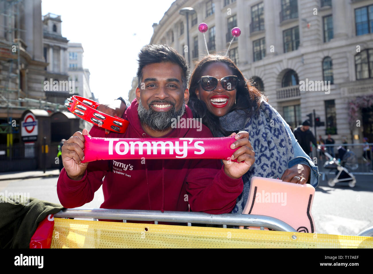 Spectators hold a Tommy's banner during the 2019 London Landmarks Half ...