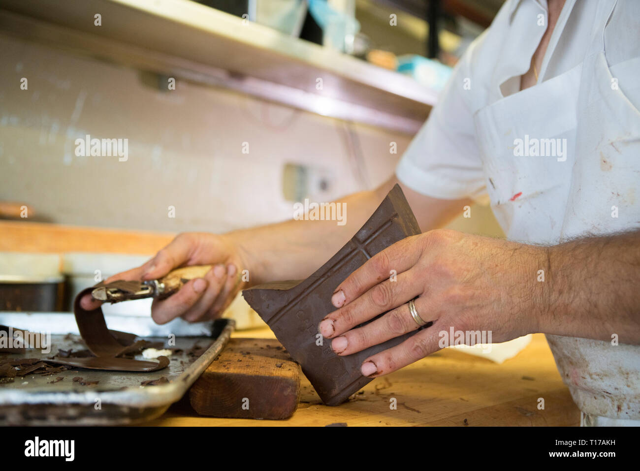 baker using chocolate in bakery Stock Photo - Alamy