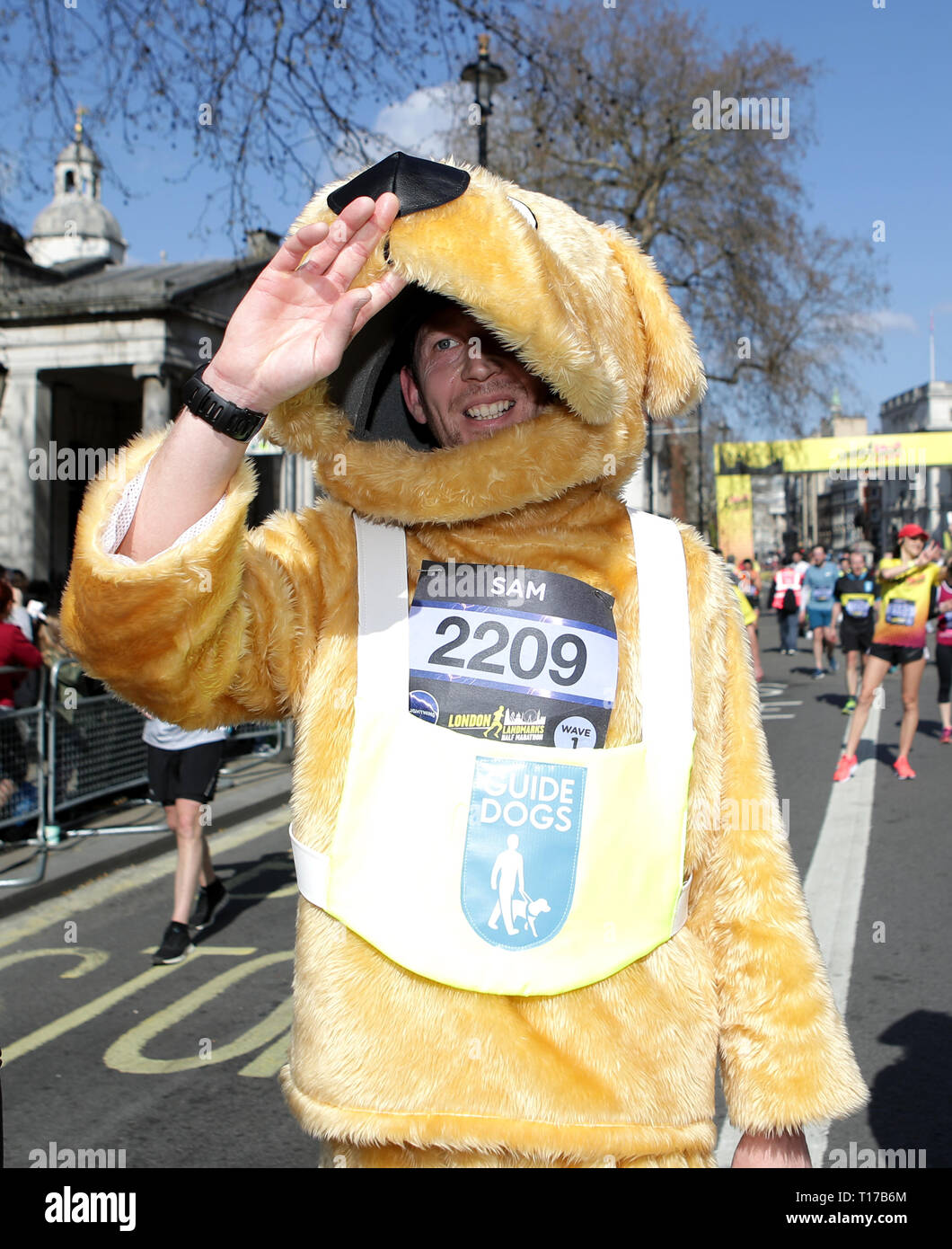Competitors in fancy dress cross the finish line during the 2019 London ...