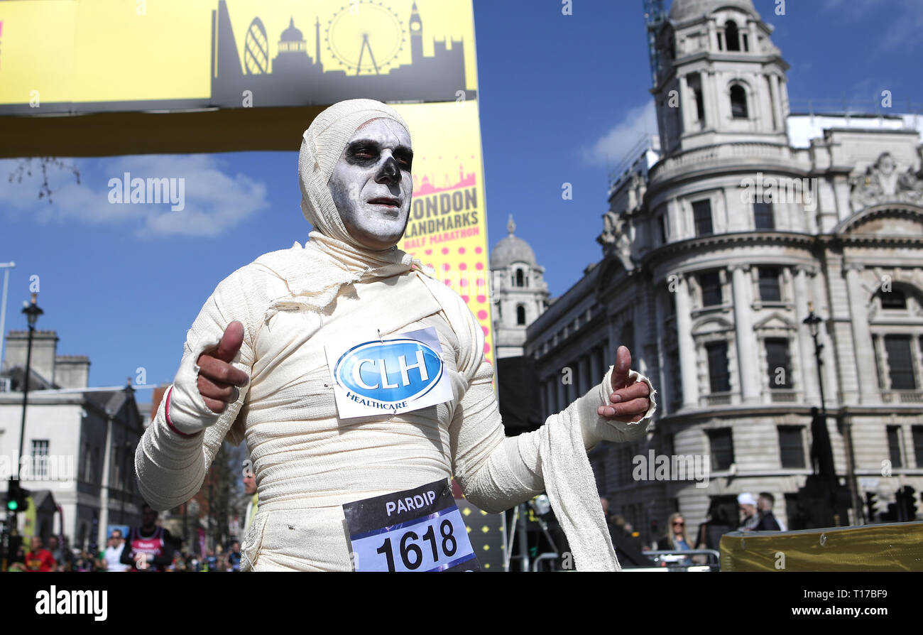 Competitors in fancy dress cross the finish line during the 2019 London ...