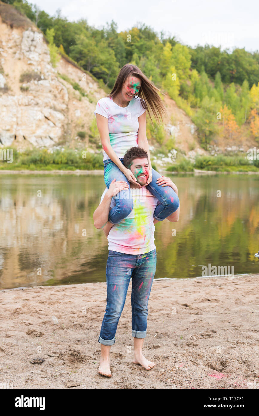 People, tourism and nature concept - Smiling couple with painted faces ...