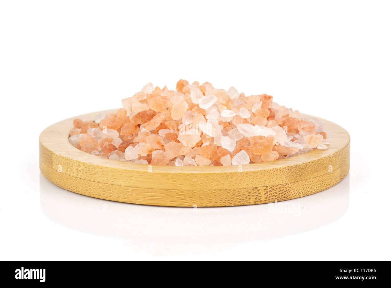 Lot of pieces of pink himalayan salt crystals on bamboo plate isolated ...