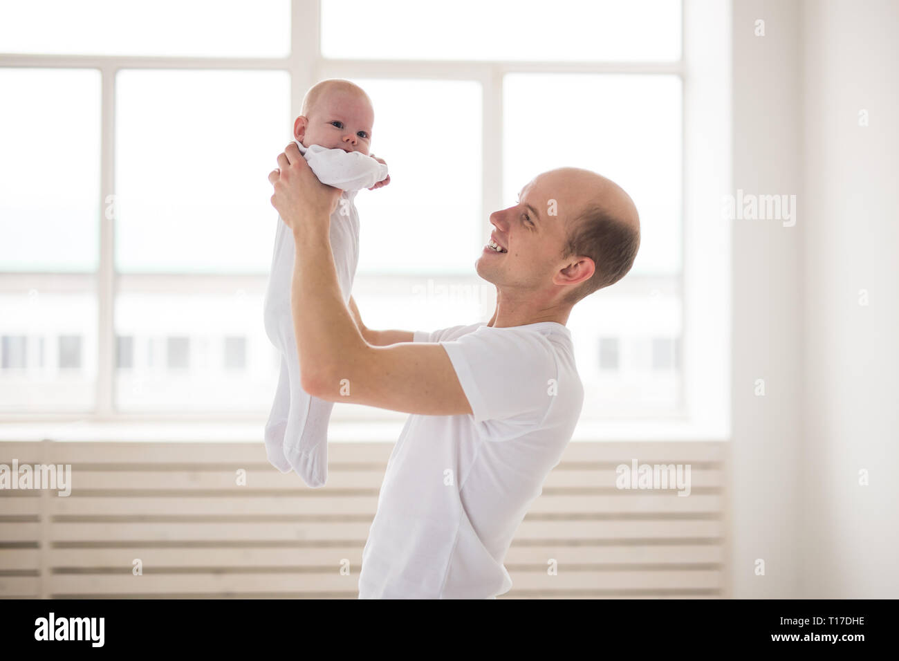 Childhood, family and fatherhood concept - proud bald father holding ...