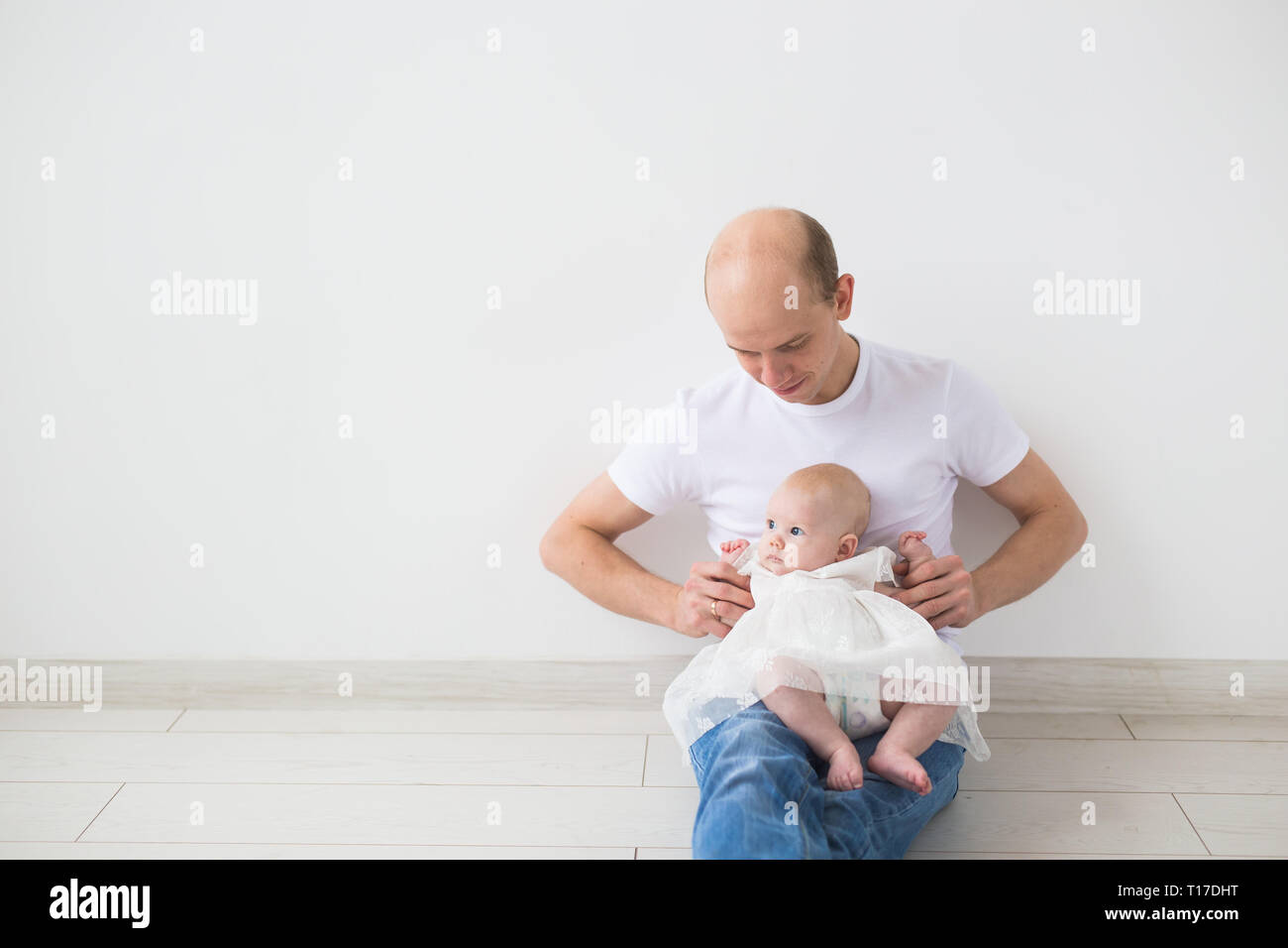 family, fatherhood and children concept - bald father holding cute ...