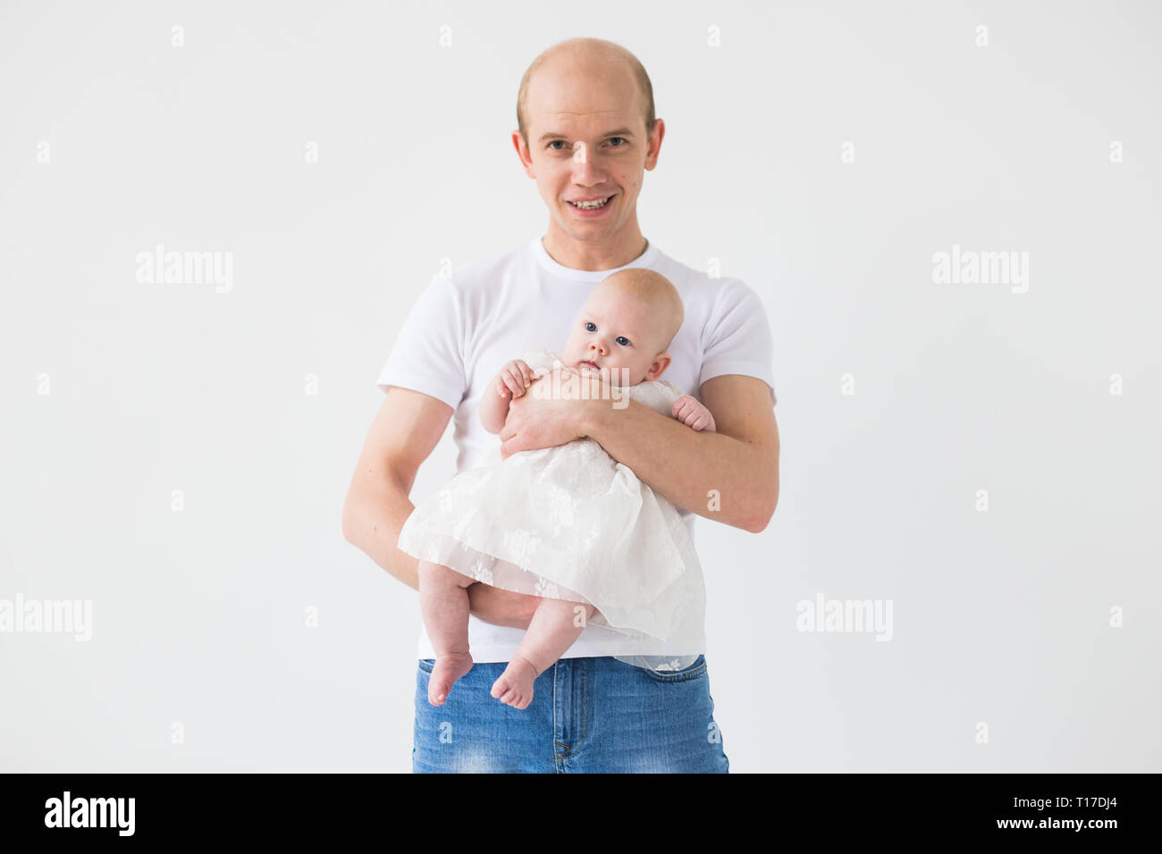 Childhood, family and fatherhood concept - proud bald father holding ...
