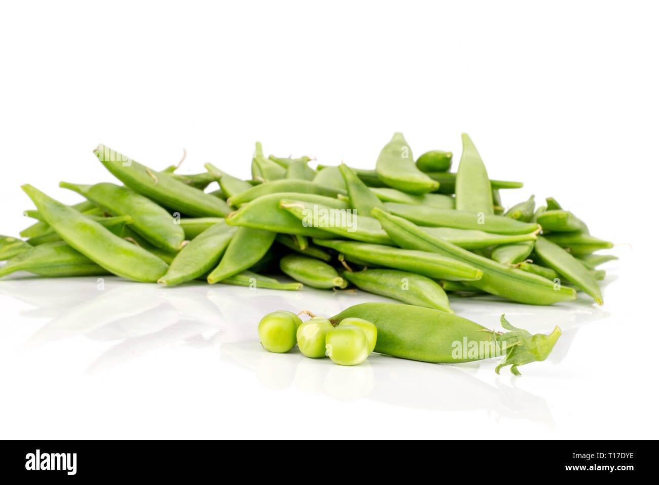 Lot of whole green sugar snap pea three peas one pod in a focus ...