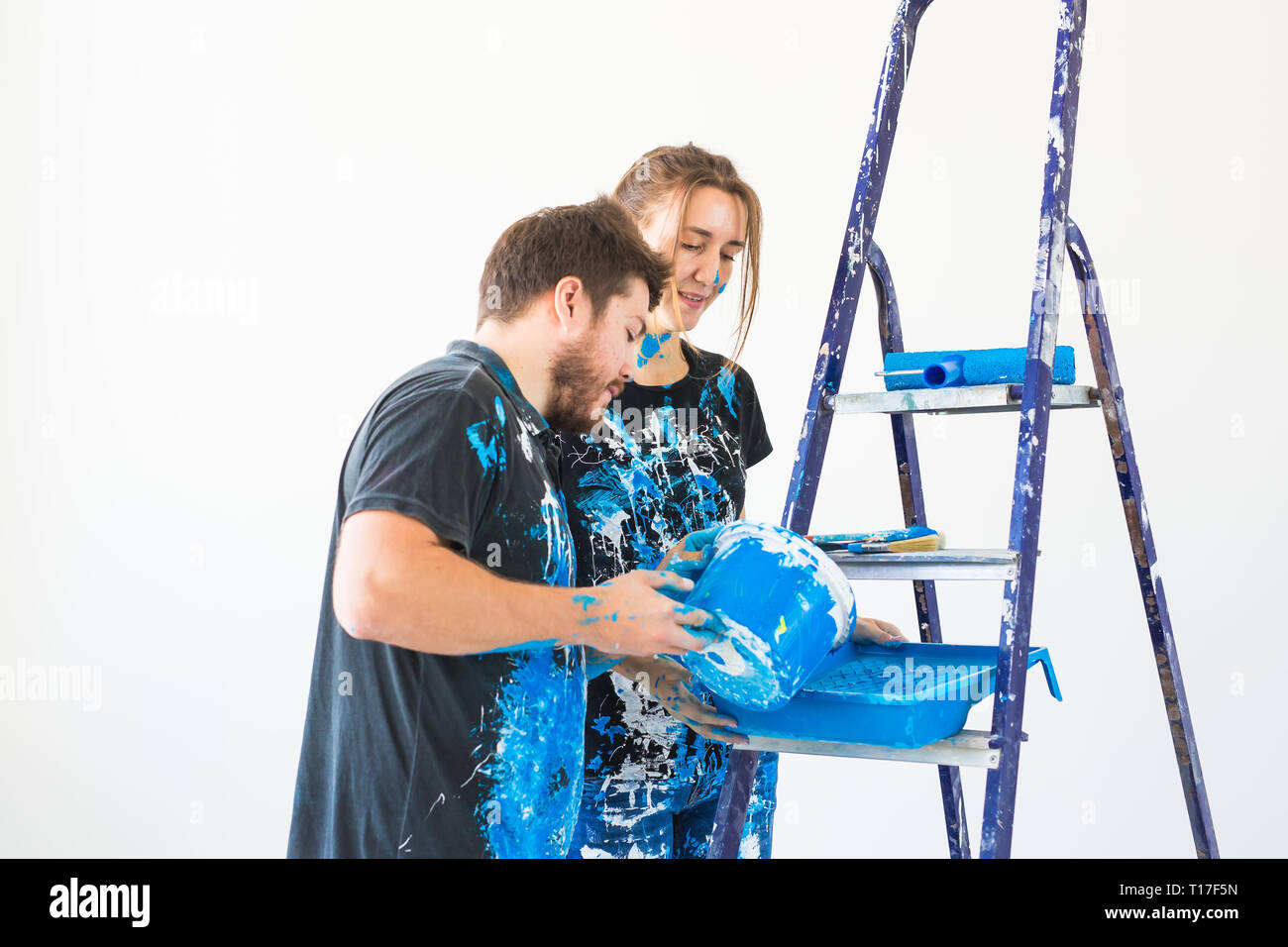 Repair, color, people concept - couple going to paint the wall, they ...