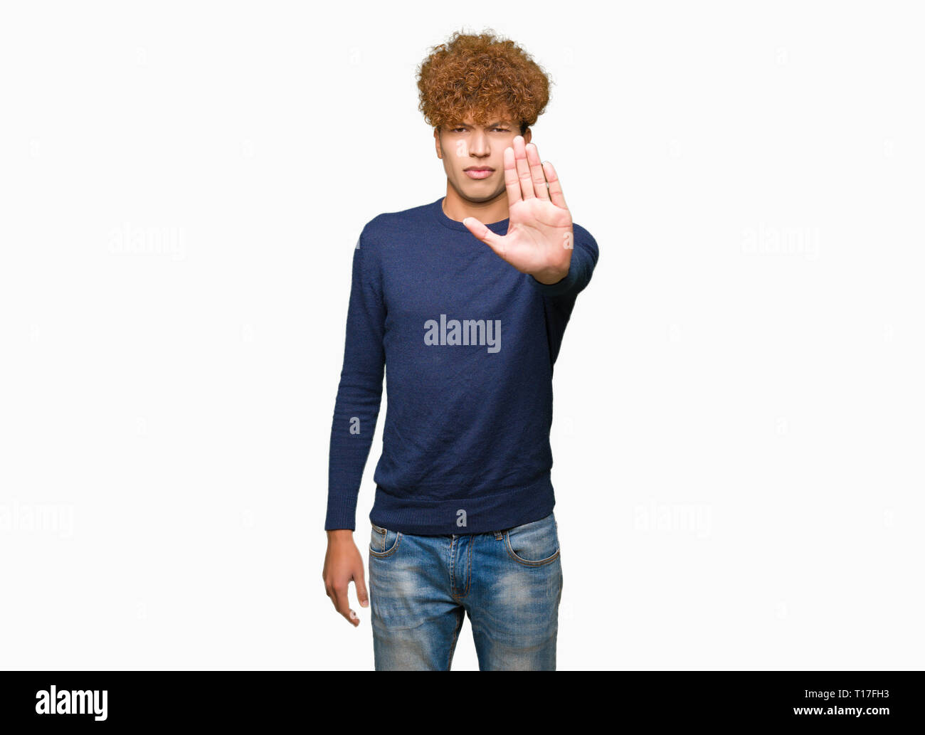 Young handsome man with afro hair doing stop sing with palm of the hand ...