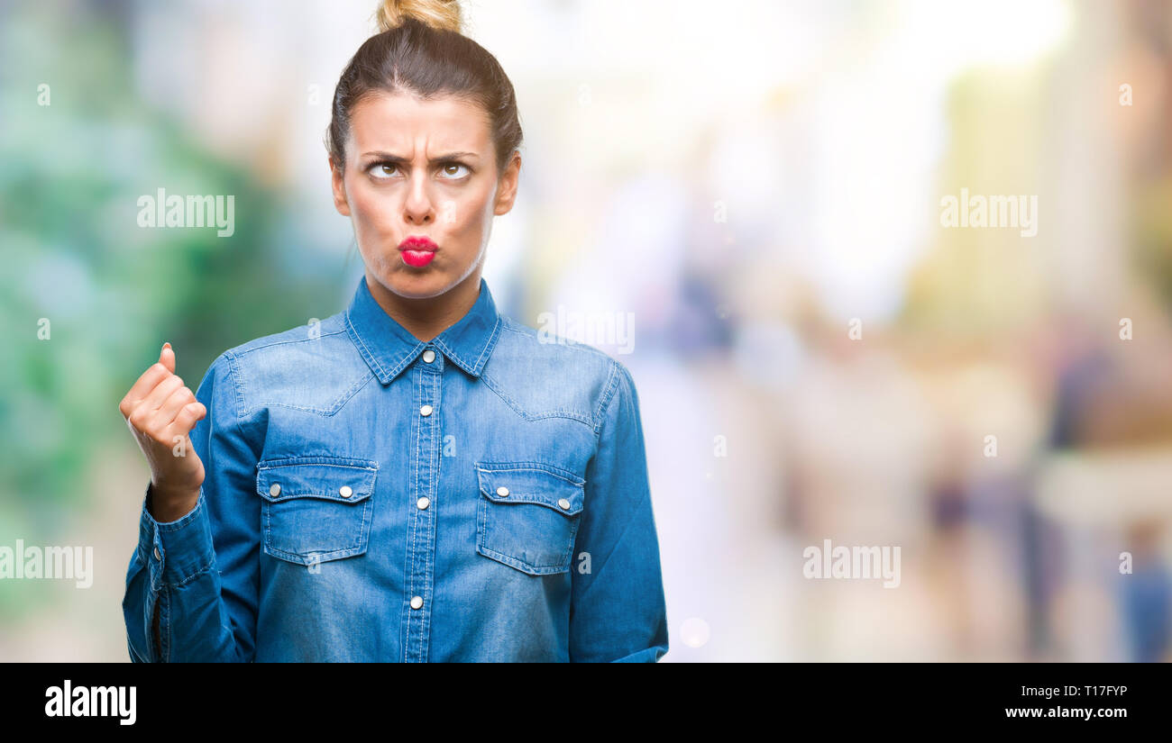 Young beautiful woman over isolated background making fish face with ...