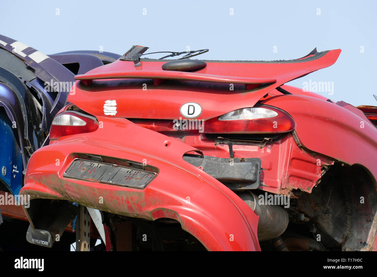 Red car wreck on a junkyard Stock Photo - Alamy