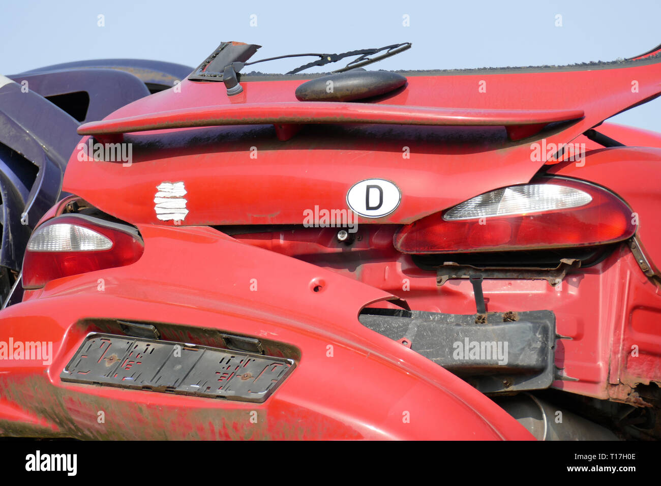 Red car wreck on a junkyard Stock Photo - Alamy
