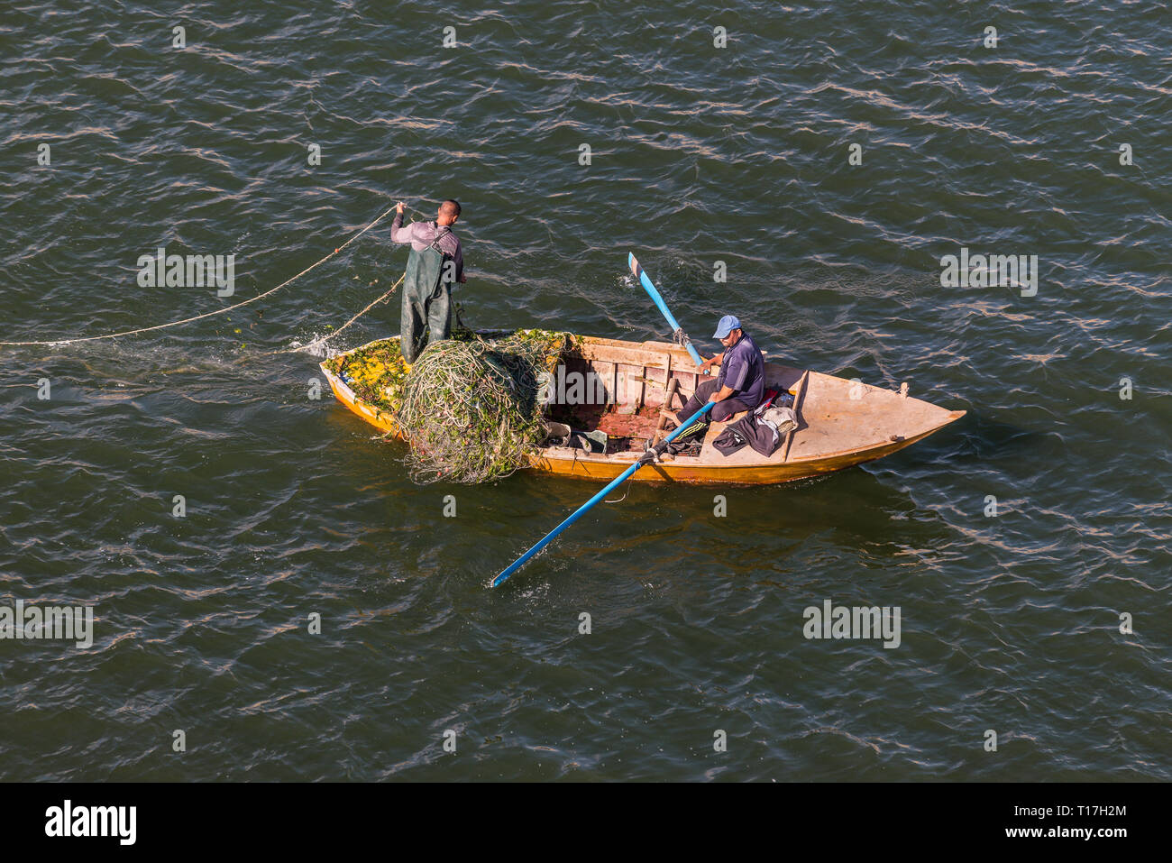 Ismailia, Egypt - November 5, 2017: Fishermen in wooden boat catch fish ...