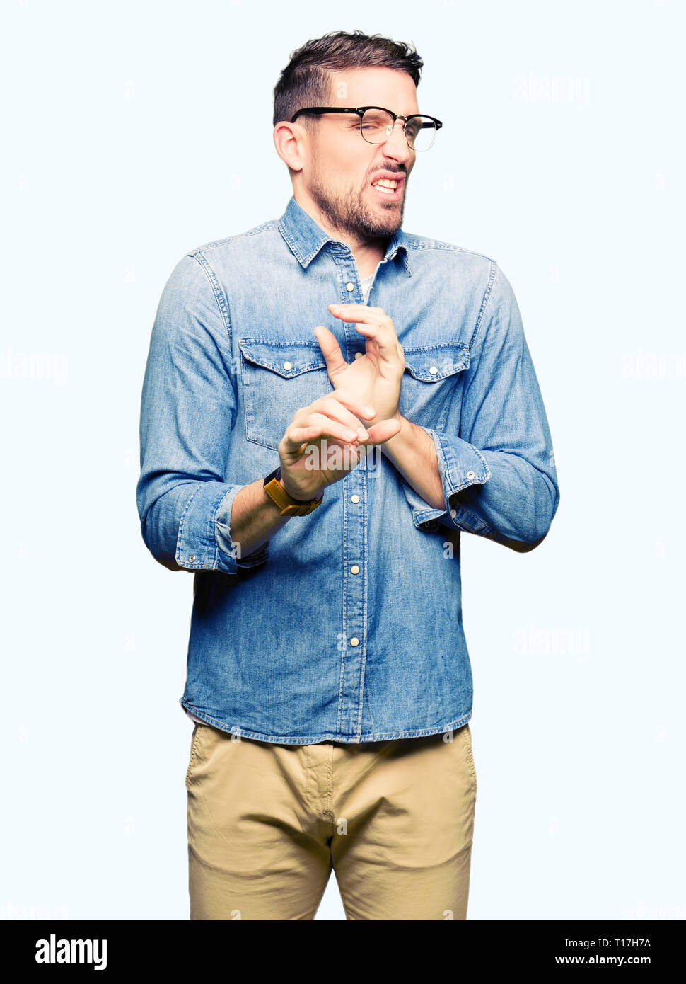 Handsome man wearing glasses disgusted expression, displeased and ...