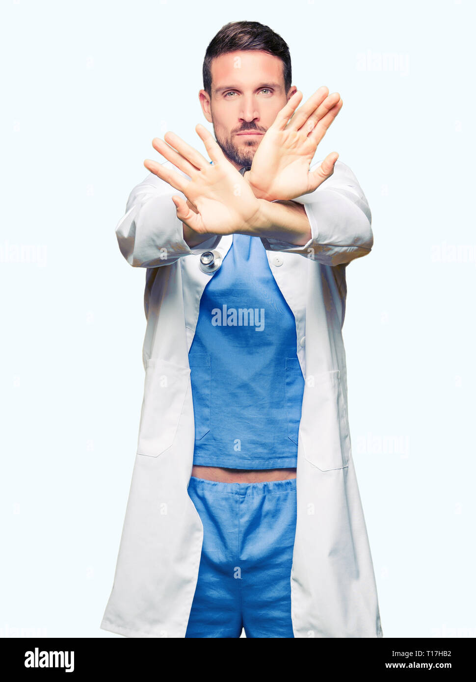 Handsome doctor man wearing medical uniform over isolated background ...