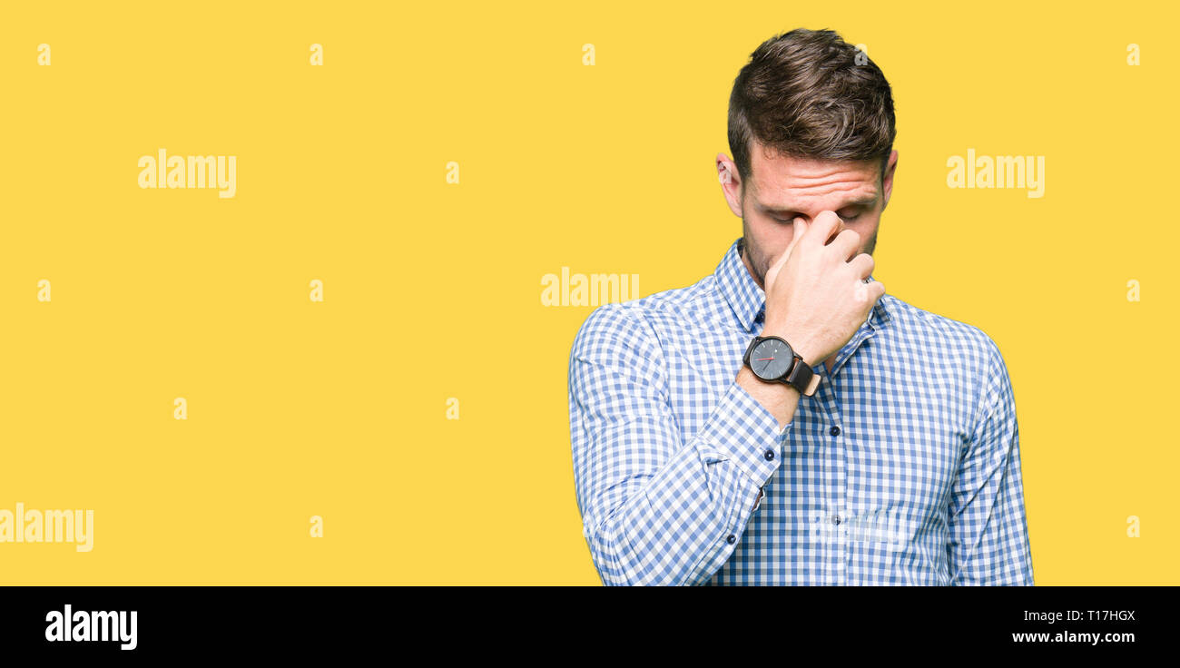 Handsome business man with blue eyes tired rubbing nose and eyes ...