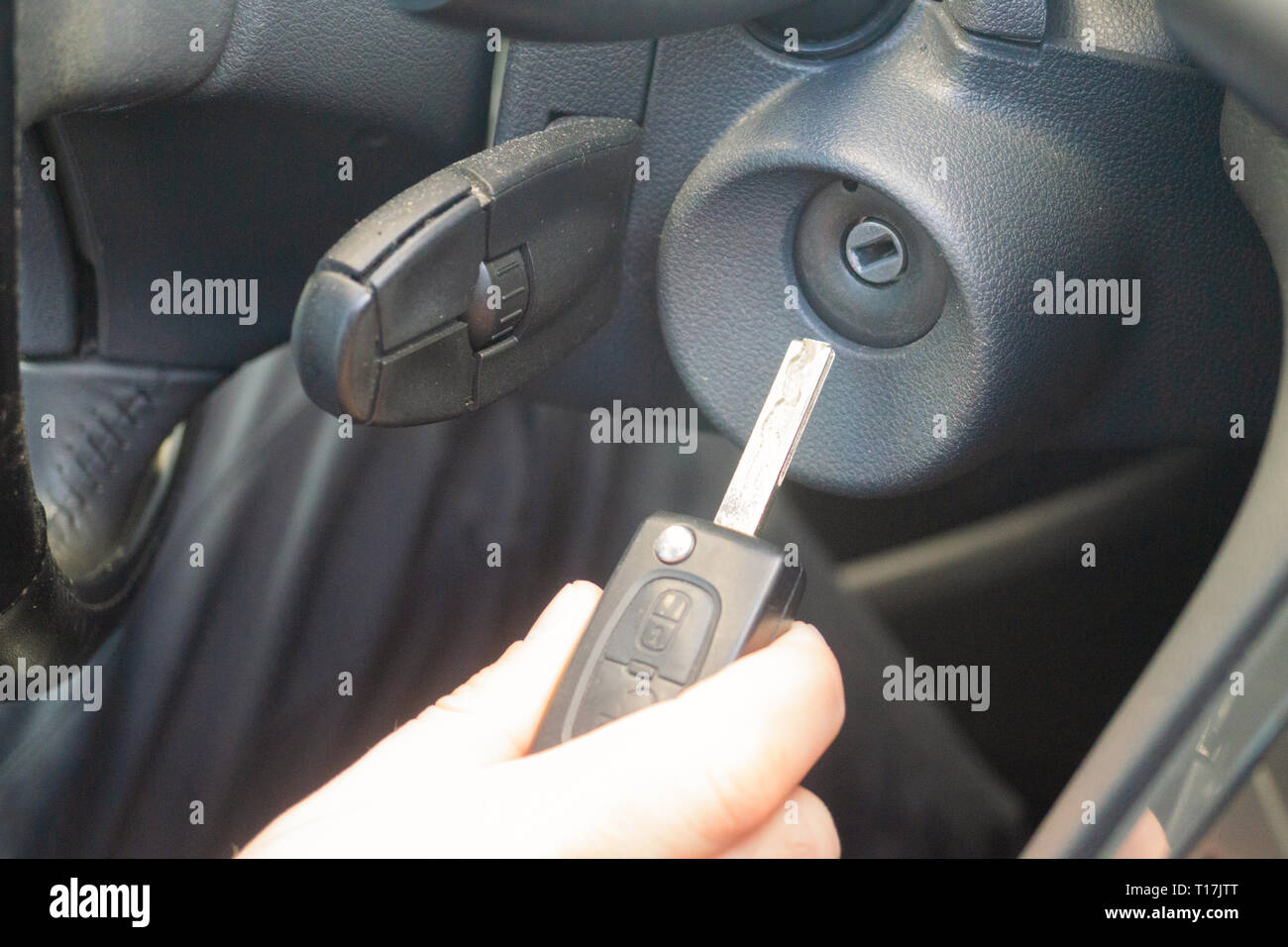 Closeup inside vehicle of hand holding key in ignition, start engine ...