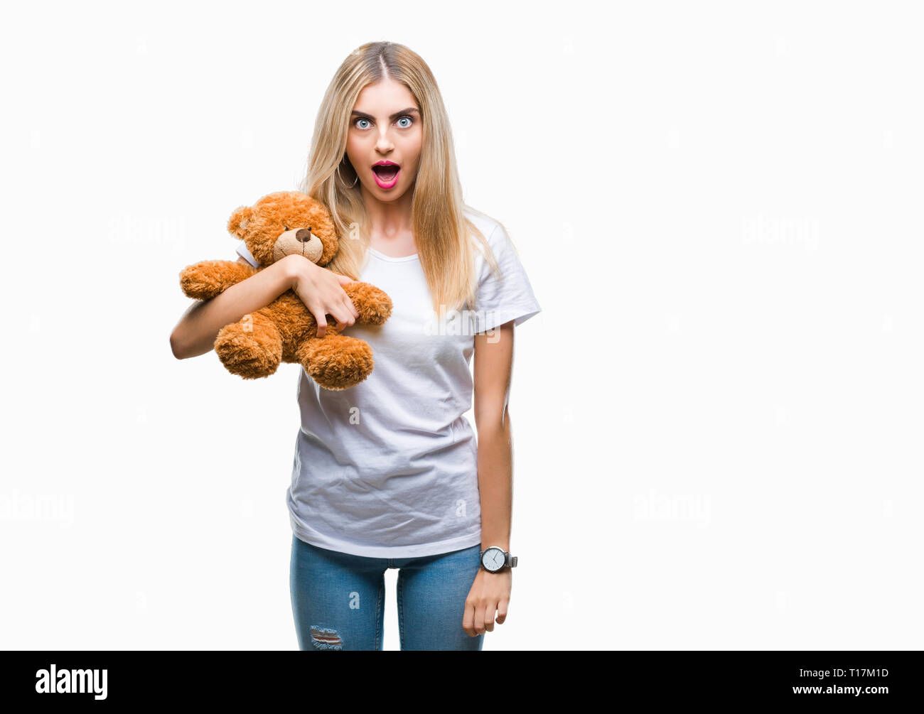 Young beautiful blonde woman holding teddy bear over isolated ...