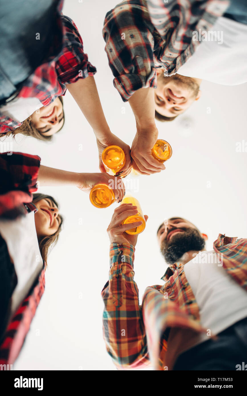 Friends clink bottles with beer, bottom view Stock Photo - Alamy