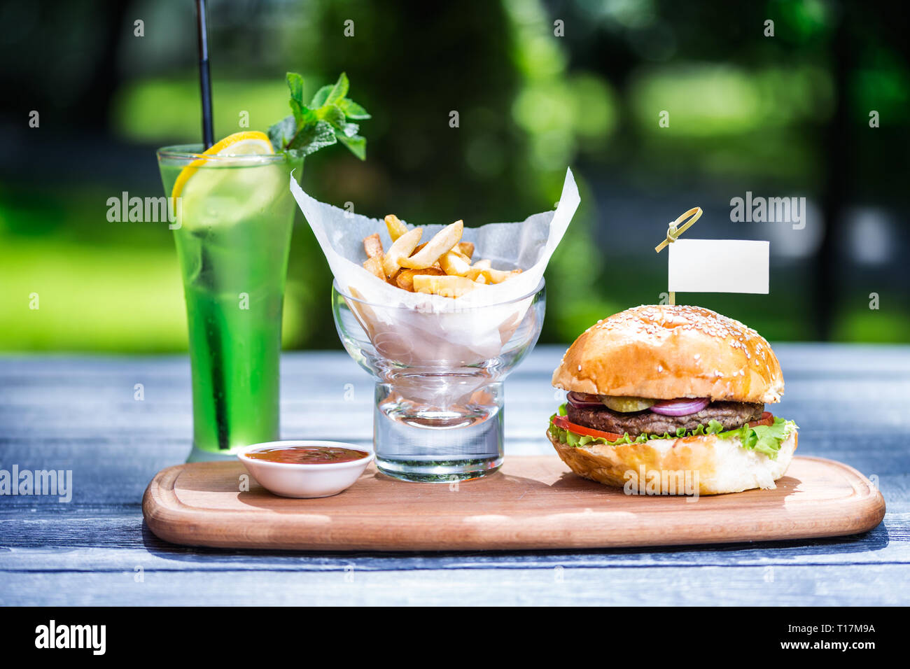 Perfect meat burger with french fries and fresh cold lemonade. On the ...
