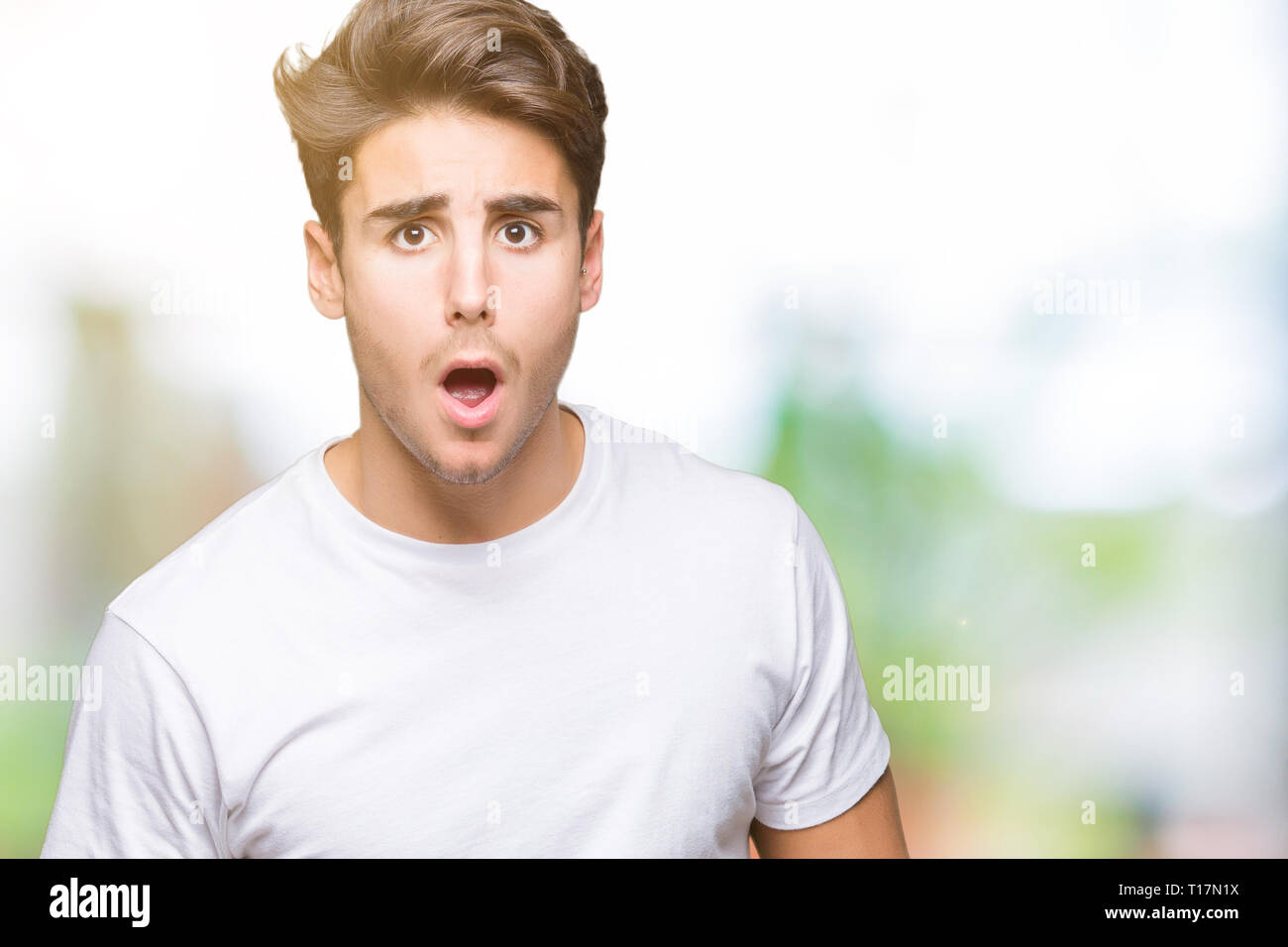 Young handsome man wearing white t-shirt over isolated background In ...
