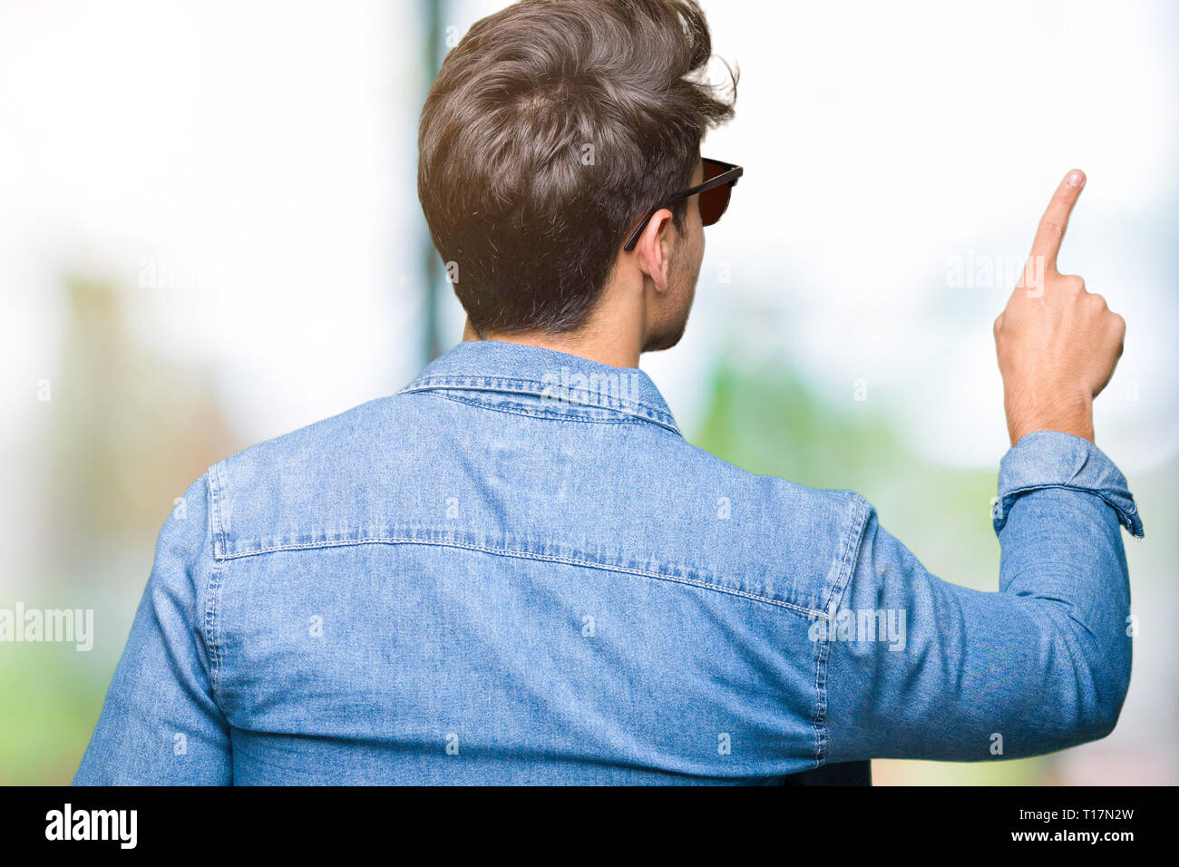 Young handsome man wearing sunglasses over isolated background Posing ...