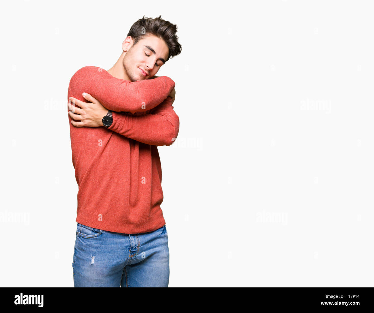Young handsome man over isolated background Hugging oneself happy and ...