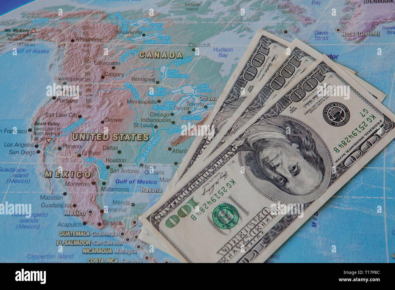 US dollar banknotes on world globe map Stock Photo - Alamy