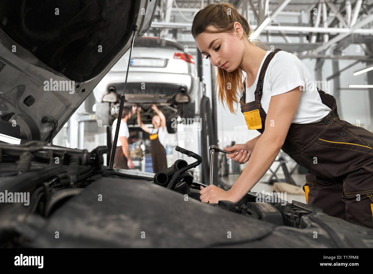 Beautiful girl with ponytail, wearing in coveralls and white t shirt ...