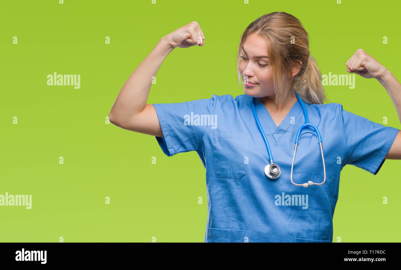 Young caucasian doctor woman wearing surgeon uniform over isolated ...