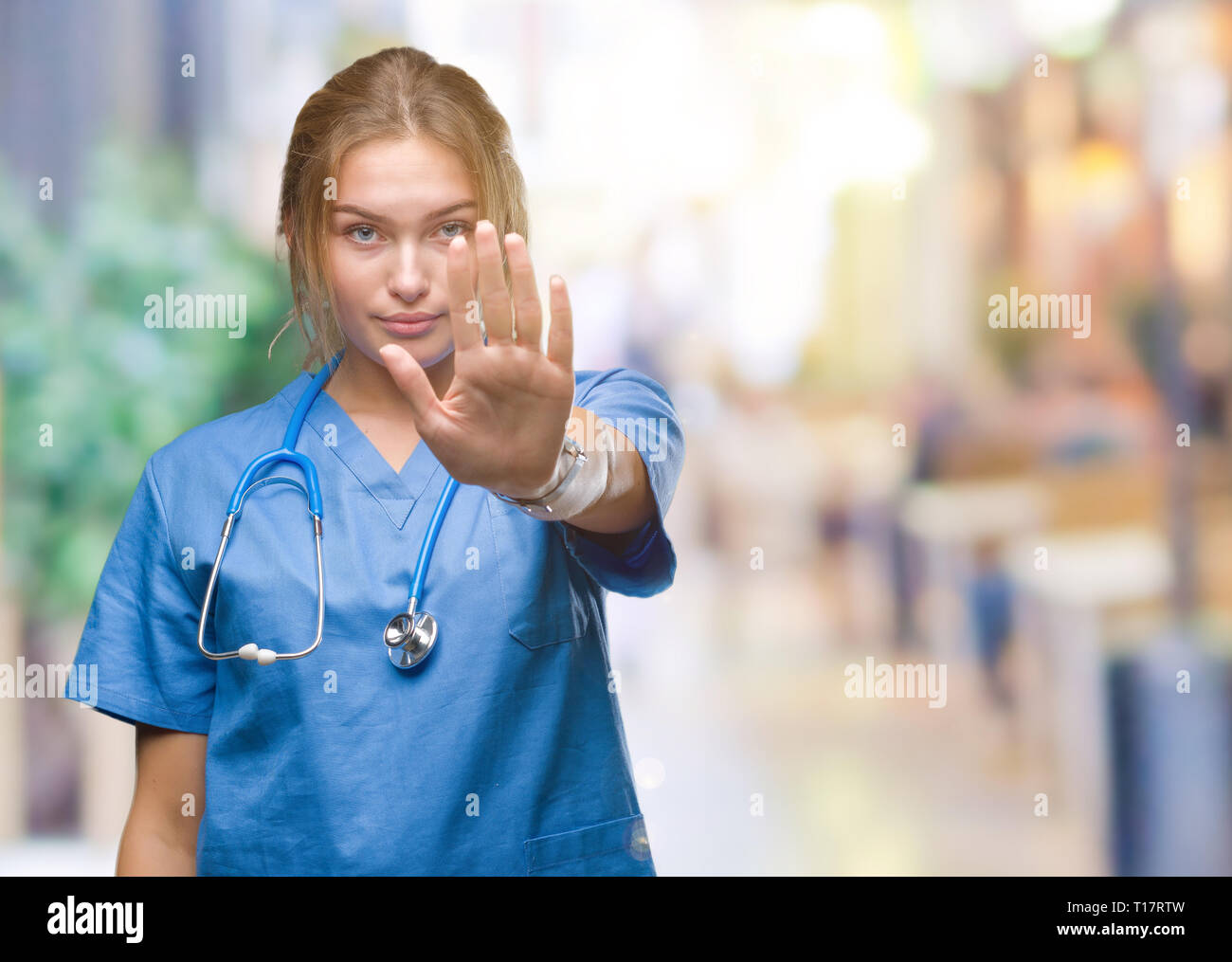 Young caucasian doctor woman wearing surgeon uniform over isolated ...