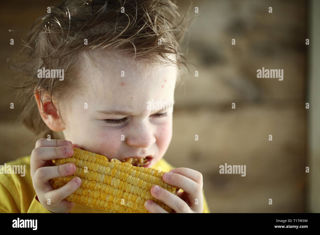 Boy eating sweet corn Stock Photo - Alamy