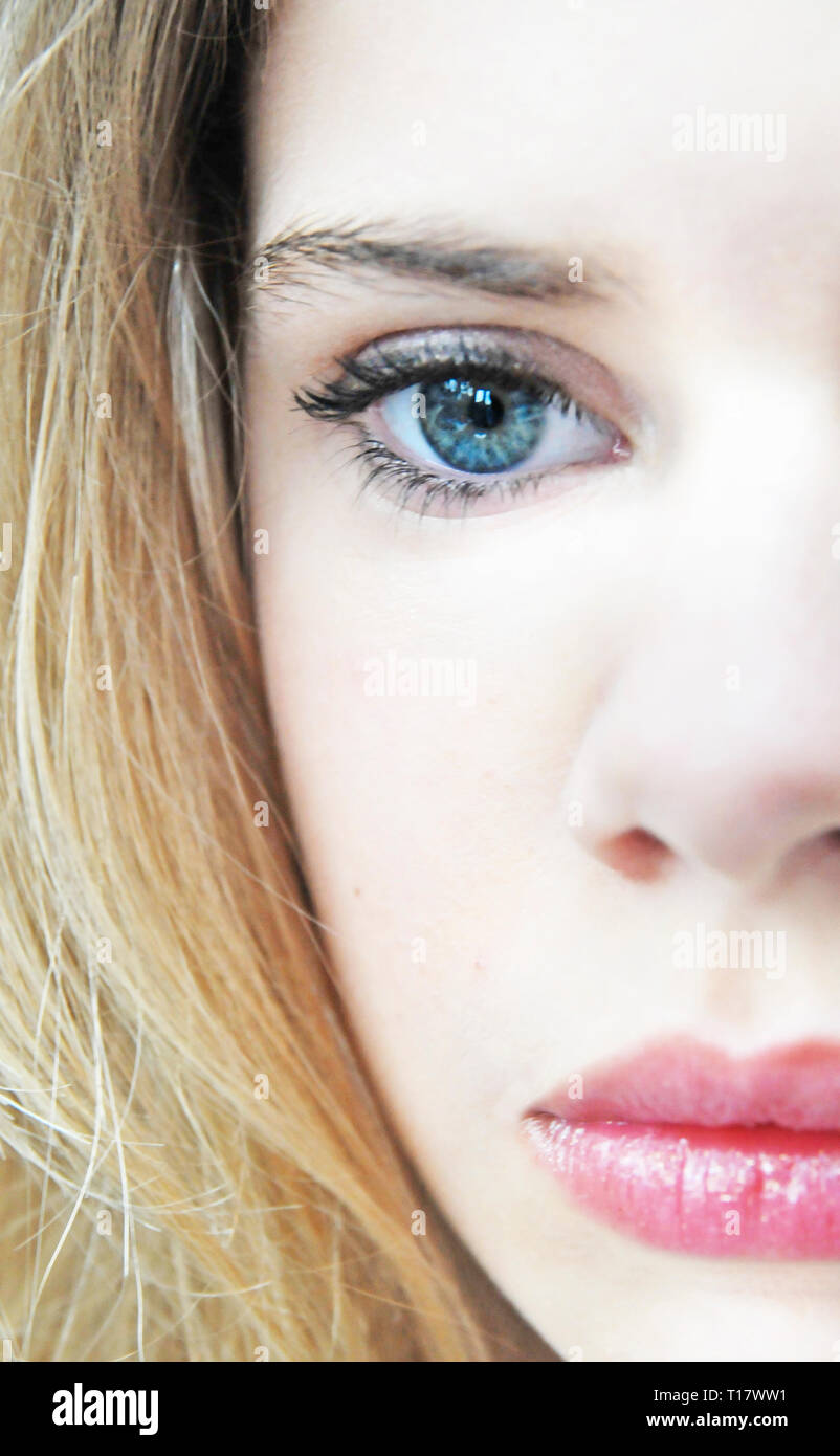 A young girl with bright blue eyes modelling for the camera Stock Photo ...