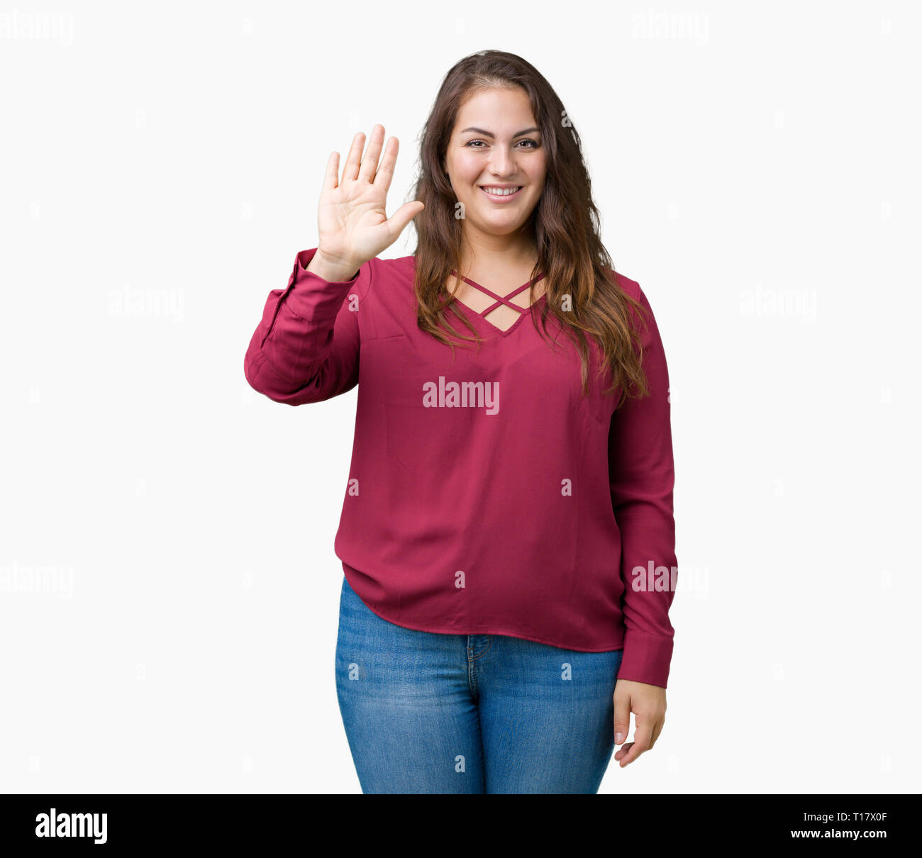 Beautiful plus size young woman over isolated background Waiving saying ...