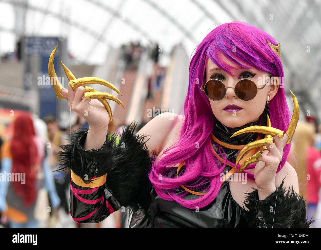 Leipzig, Germany. 24th Mar, 2019. A cosplayer presents herself as an ...