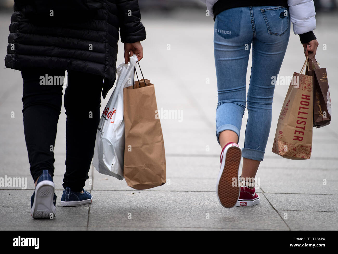 Berlin, Germany. 22nd Mar, 2019. Two women with shopping bags cross a ...