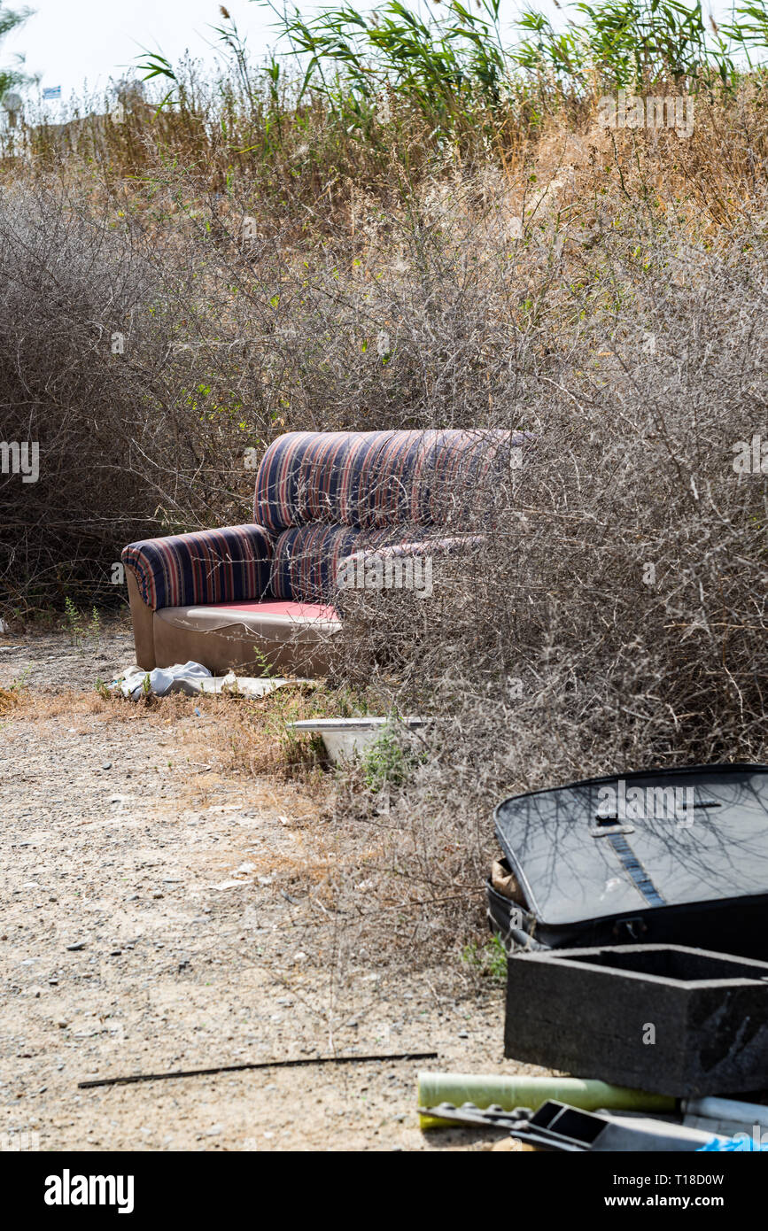 Sofa thrown away in natural area - forest part - illegal dumping trash ...