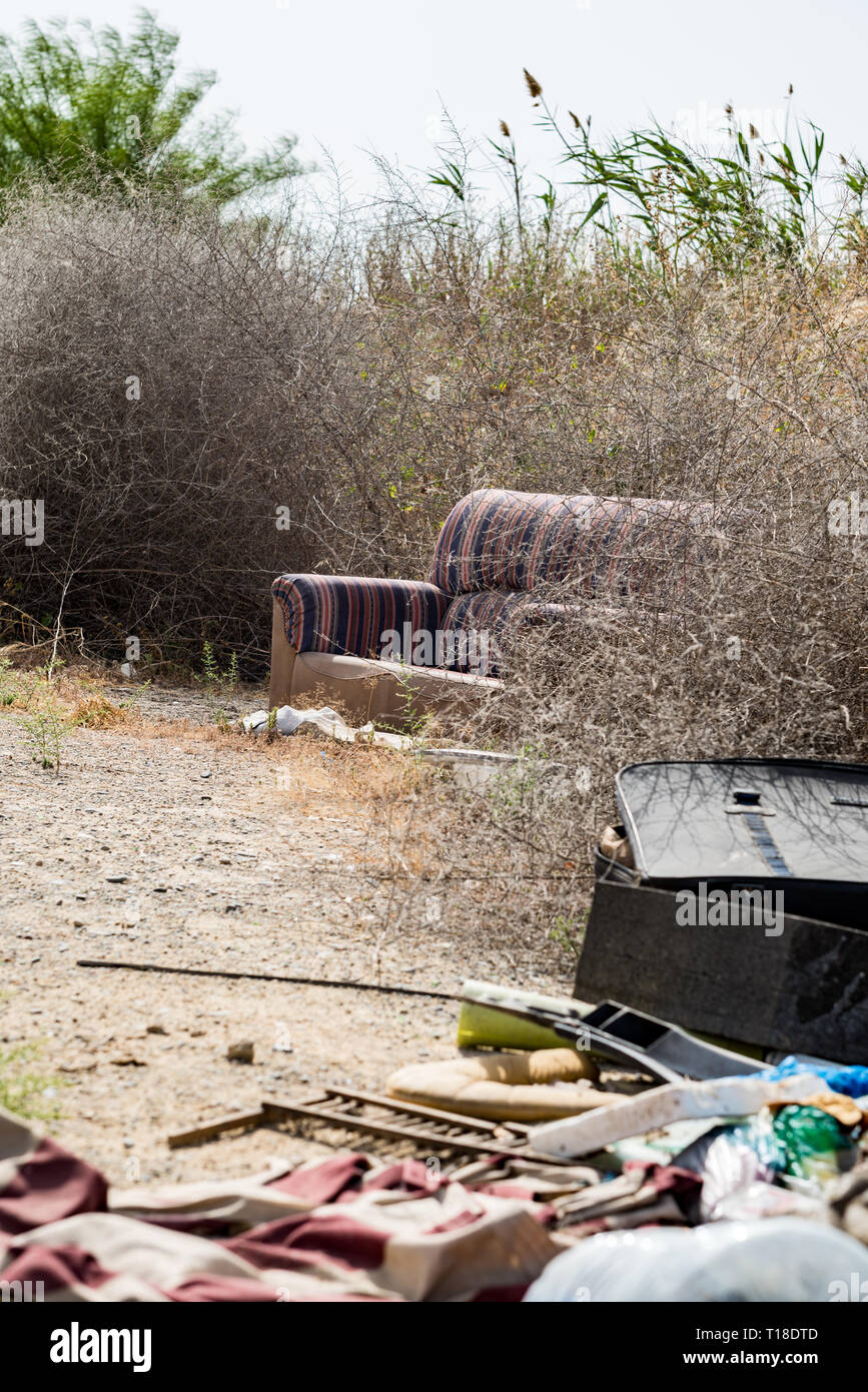 Sofa thrown away in natural area - forest part - illegal dumping trash ...