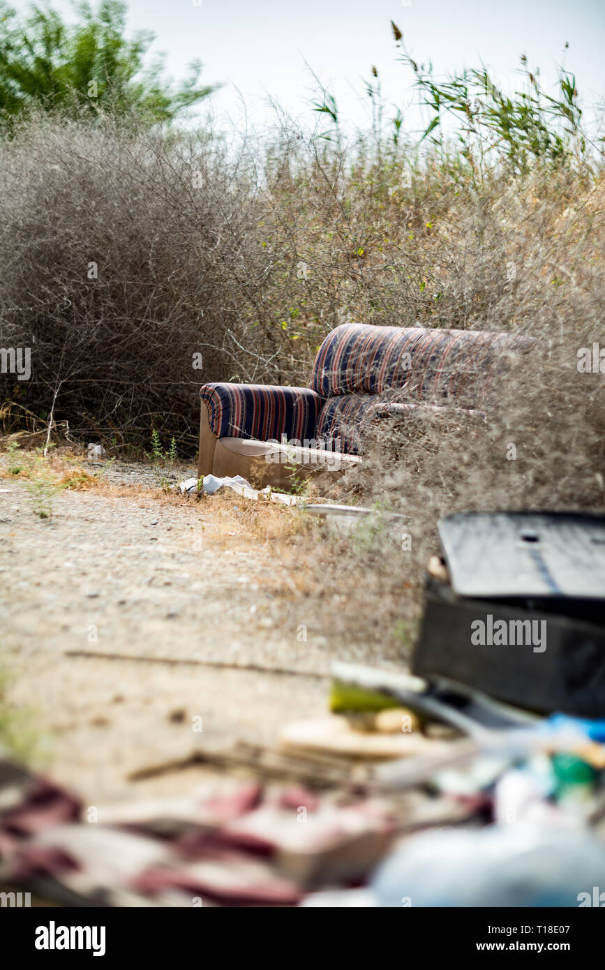 Sofa thrown away in natural area - forest part - illegal dumping trash ...