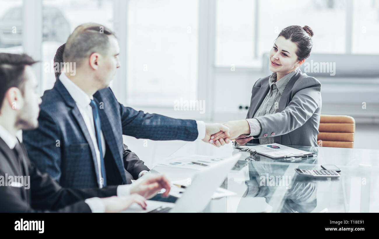 concept of partnership:a handshake of a Manager and a customer at the ...