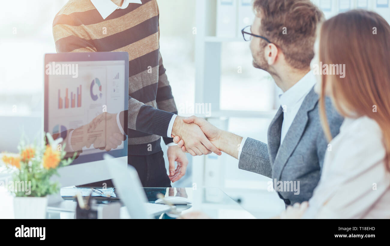 friendly handshake of employees in the workplace at the beginning Stock ...